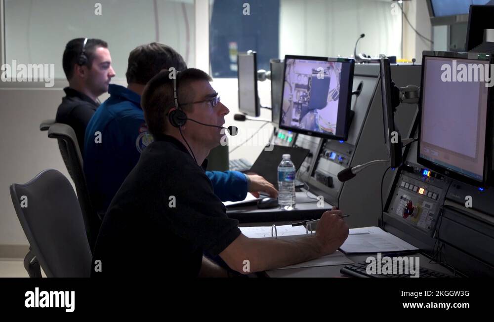 Staff monitoring computer screens in control room during centrifugal ...