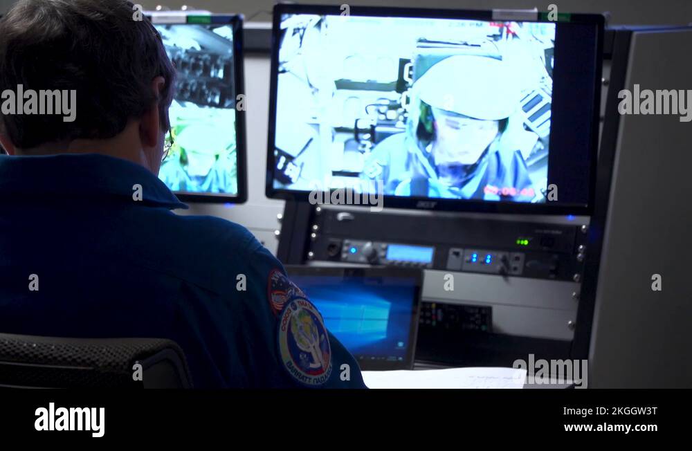 Staff monitor computer screens in control room during centrifuge ...