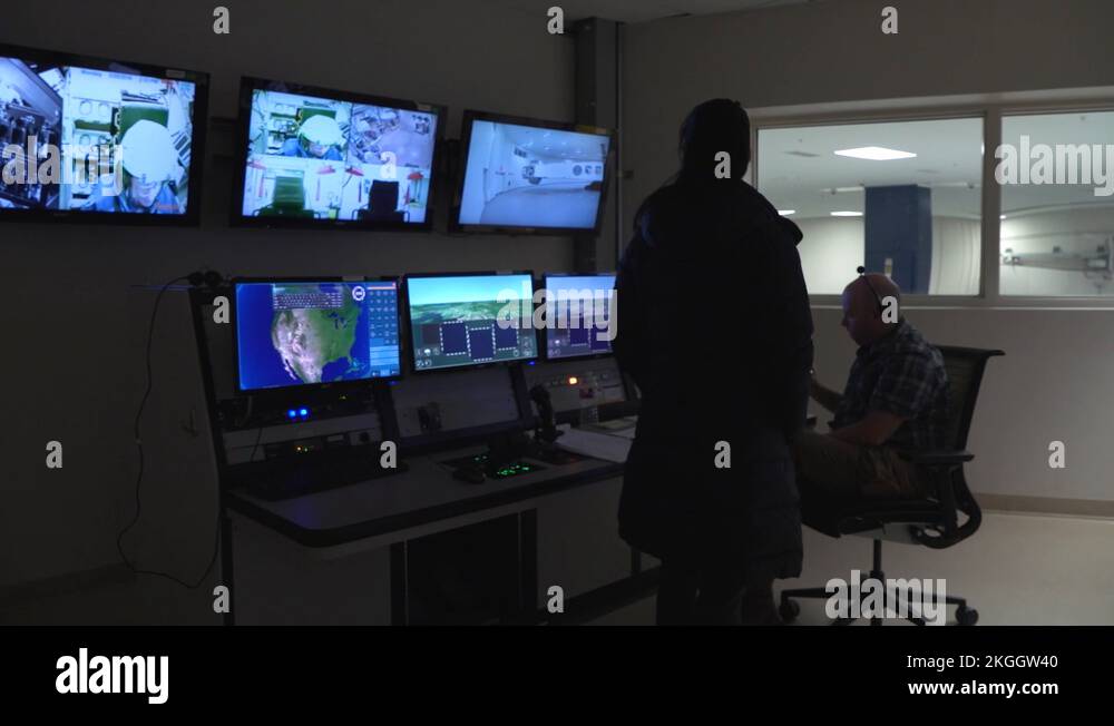 Staff monitor computer screens in control room during centrifuge ...