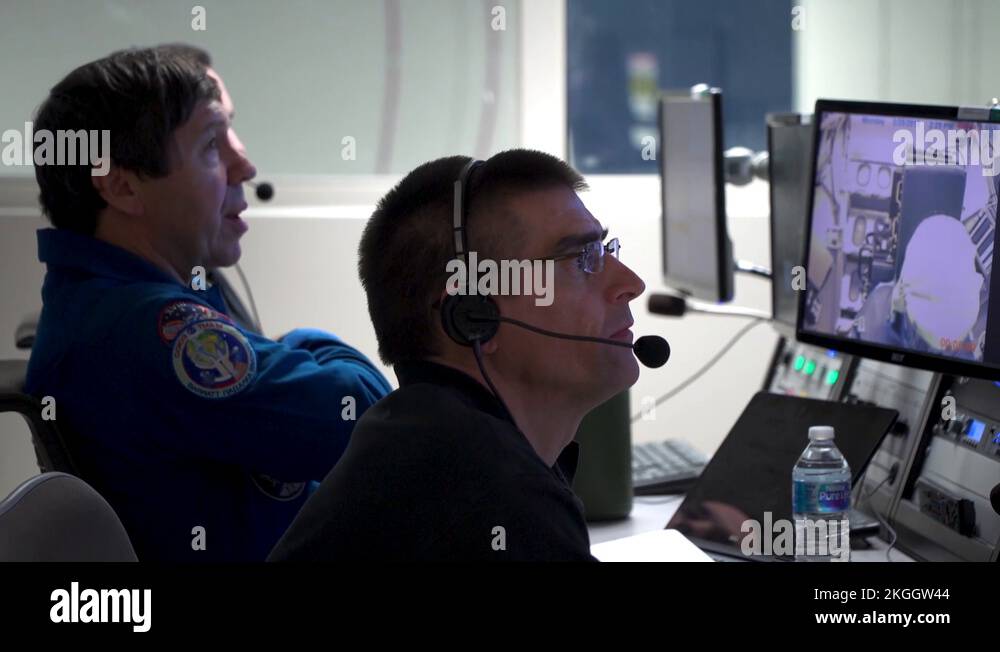 Personnel monitor computer screens in control room during centrifuge ...