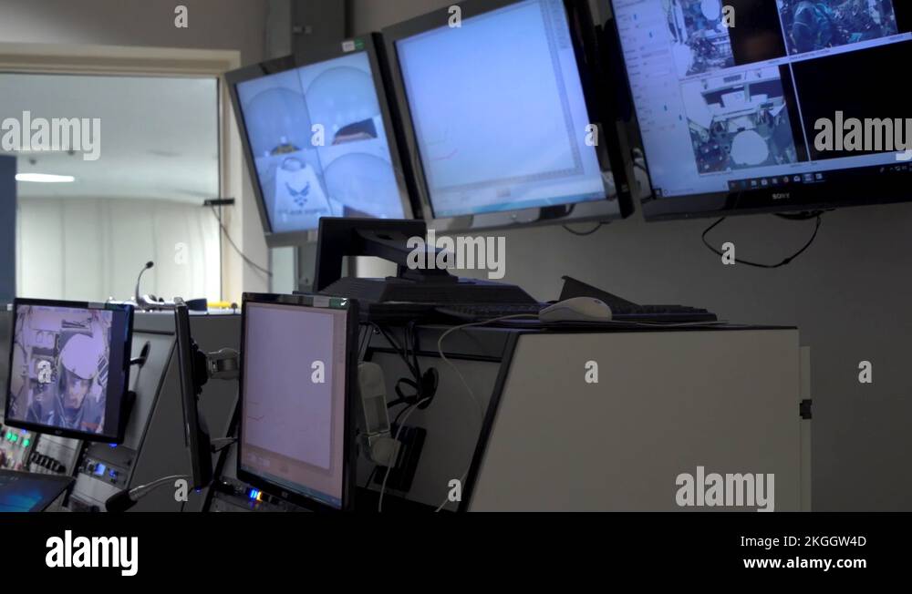 Personnel monitor computer screens in control room during centrifuge ...