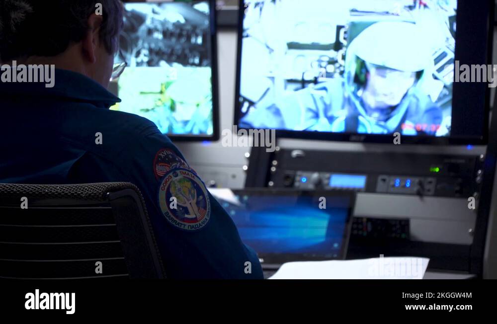 Staff monitor computer screens in control room during centrifuge ...