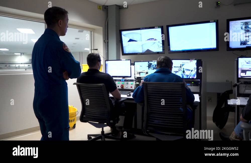 Staff monitoring computer screens in control room during centrifugal ...