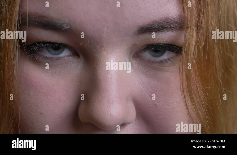 Closeup shoot of young attractive overweight female face with gray eyes ...