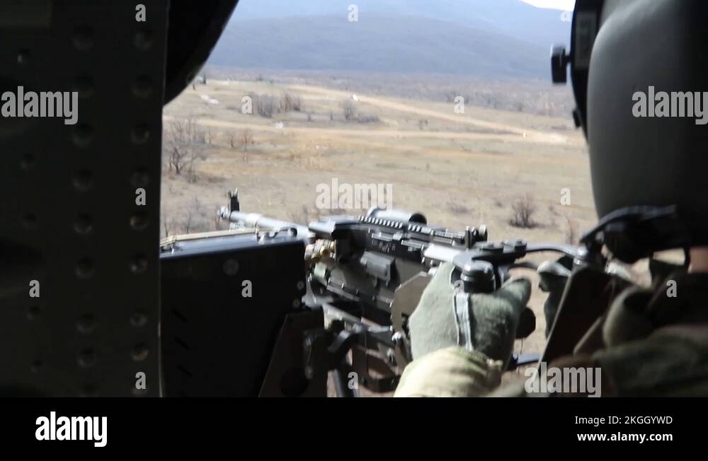 Door gunner firing machine gun from helicopter over Novo Selo Range, Bulgaria Stock Video ...