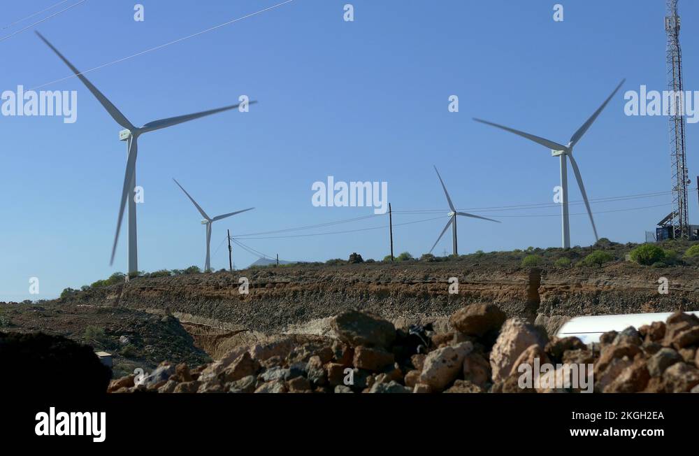 Wind Turbines With Rotating Blades Next to Electrical Towers and Power ...