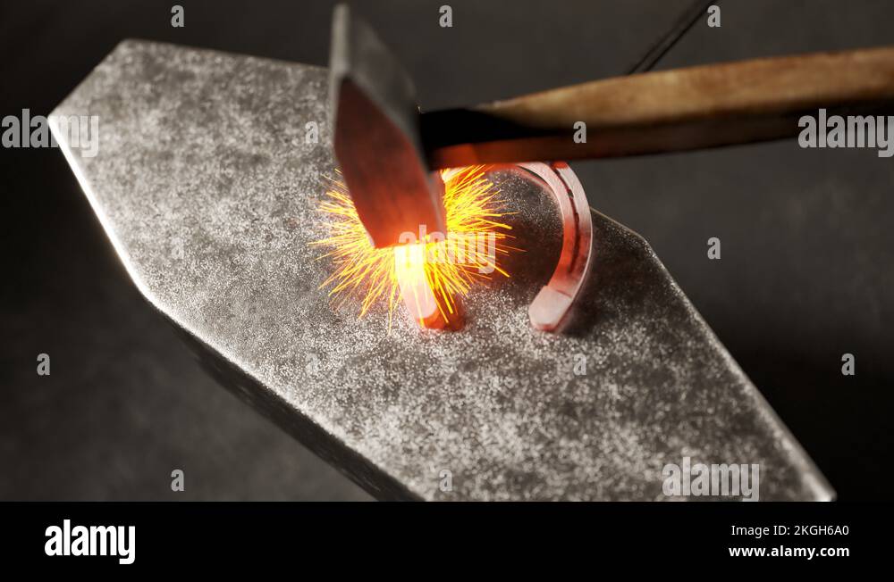 Traditional forge with an old anvil. Hammer is hitting glowing, hot ...