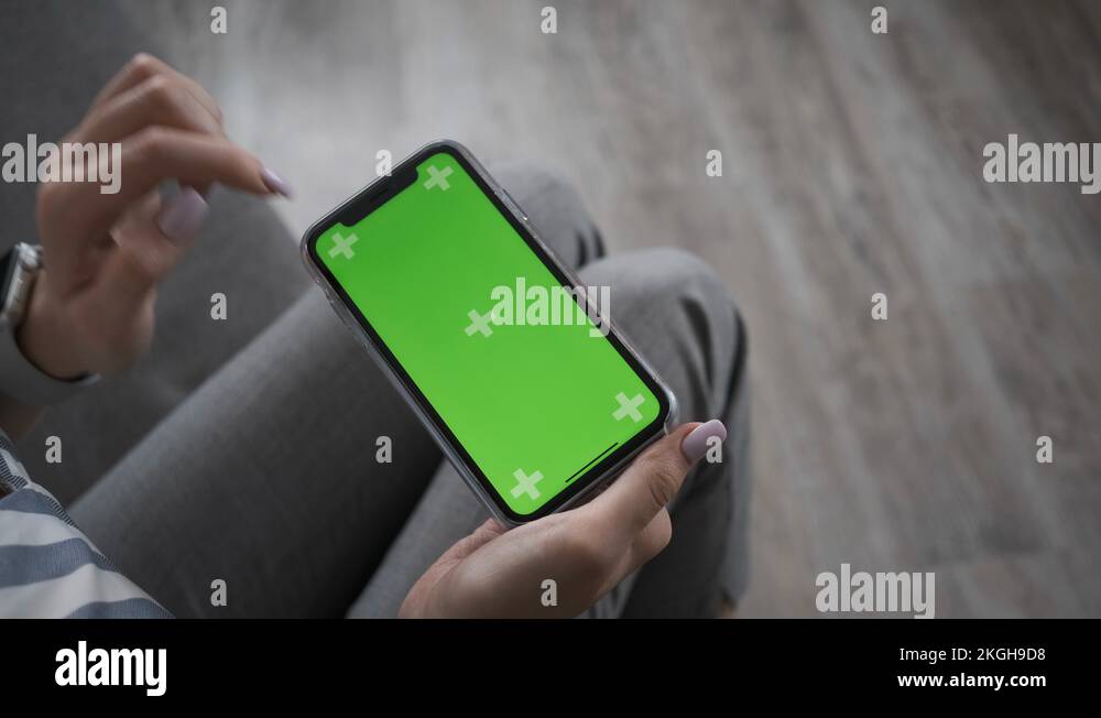 Smartphone in a horizontal position and a female's hand touches the ...