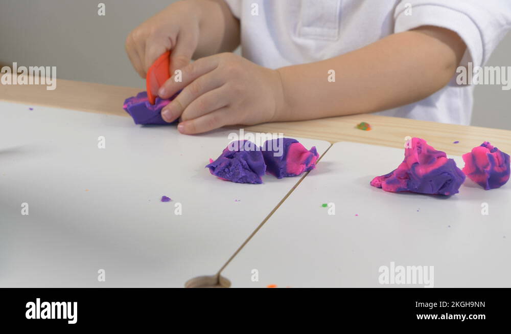 A 2-year-old preschool kid playing with modeling clay (compound Stock ...