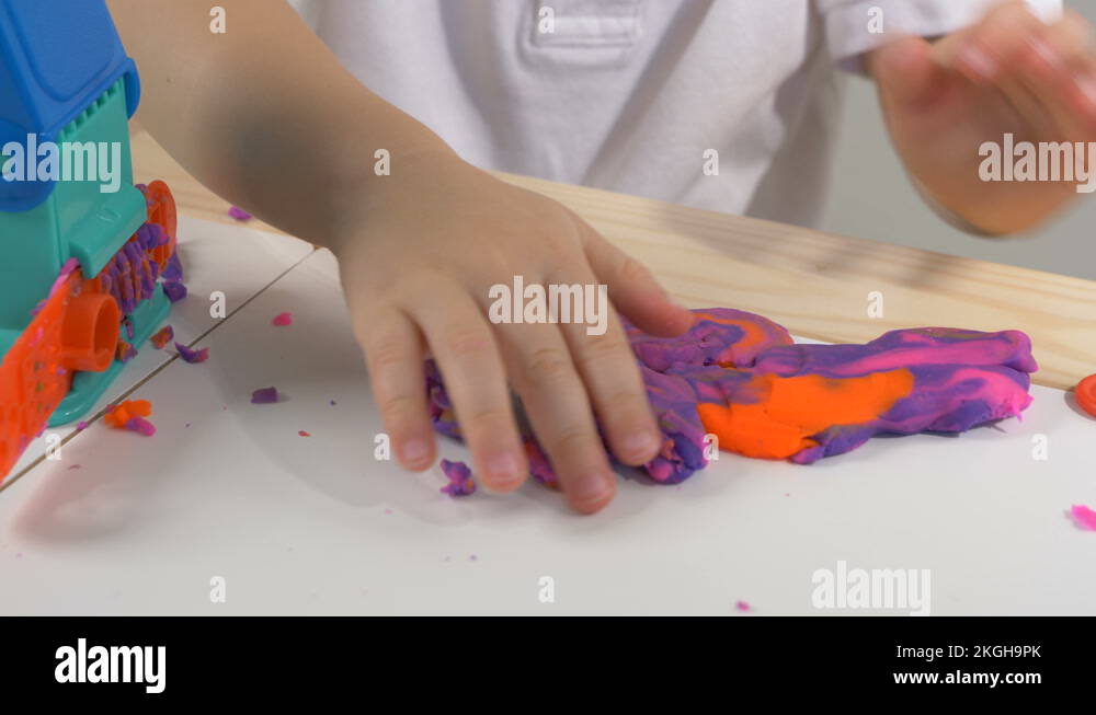 A 2-year-old preschool kid playing with modeling clay (compound Stock ...