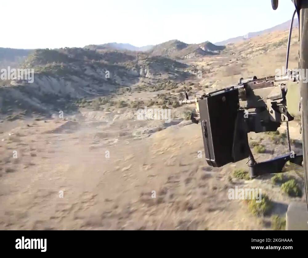 Door gunner firing M240B machine gun from helicopter Stock Video ...