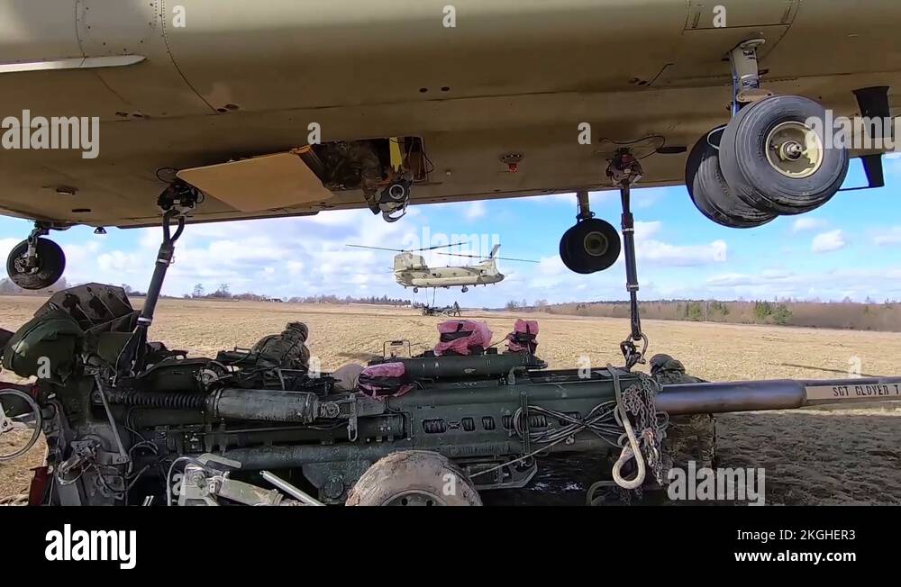 Soldiers run from under CH-47 Chinook after attaching M777 Howitzer sling load Stock Video ...