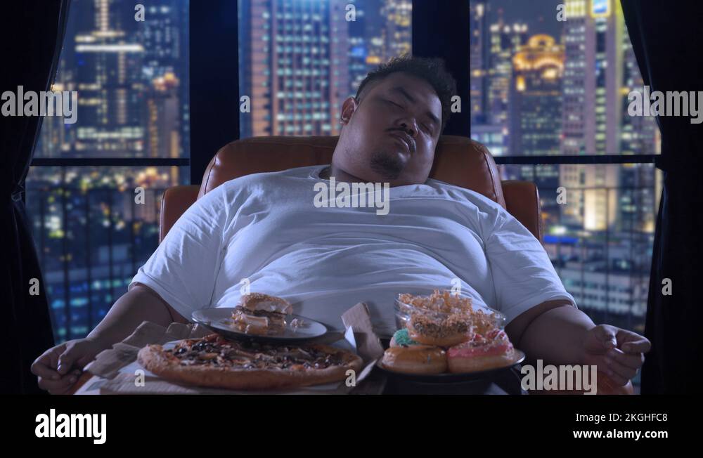 Gorged man sleeping on sofa with junk foods Stock Video Footage - Alamy
