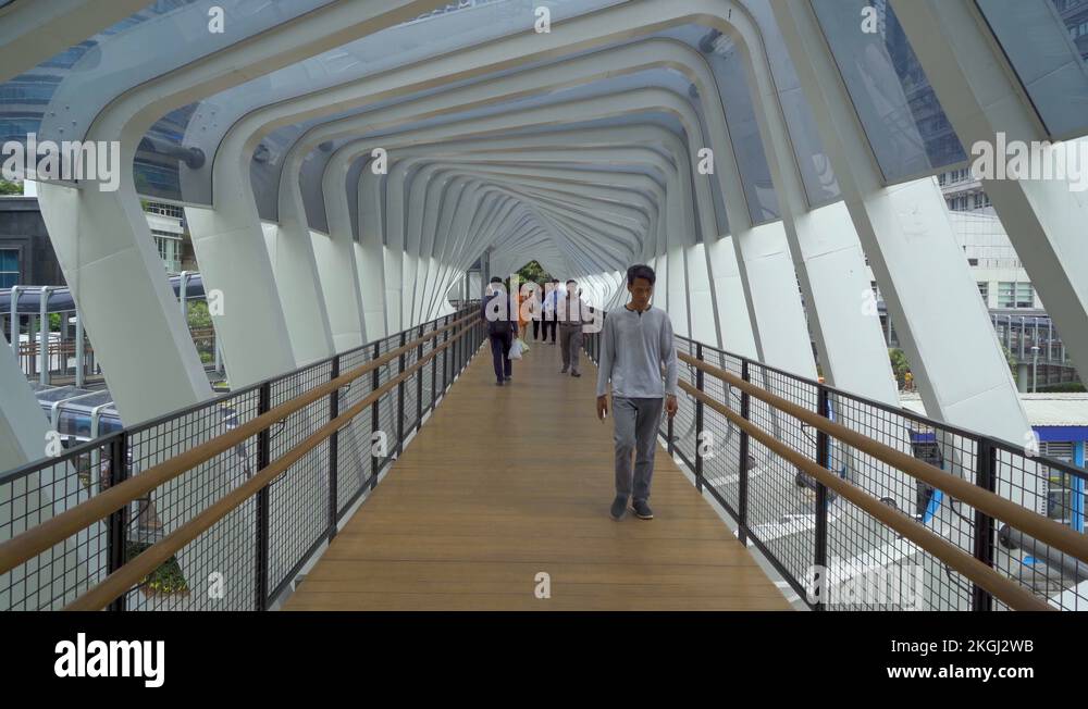 Pedestrian walk inside modern pedestrian bridge Stock Video Footage - Alamy