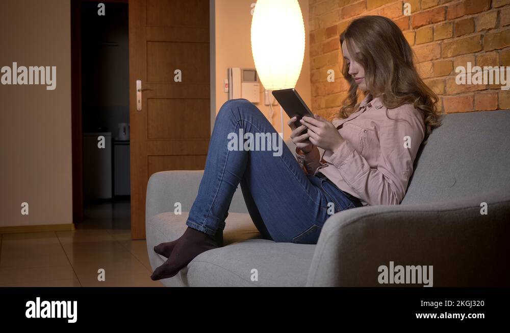 Portrait in profile of young teenage girl watching attentively into ...