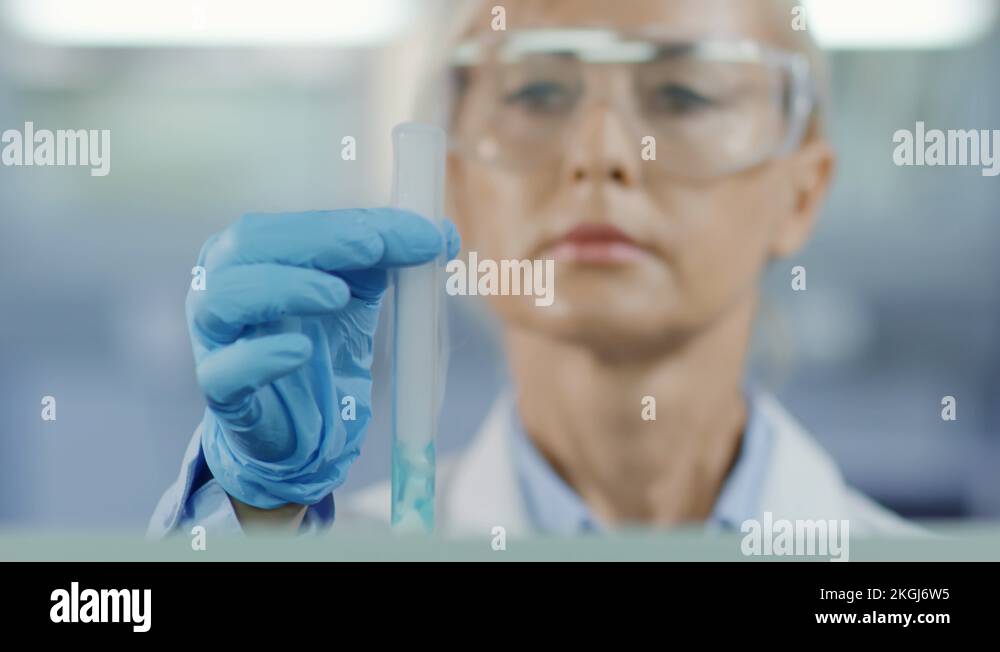 Cinemagraph of Female Chemist Looking at Vaporizing Chemical in Test ...