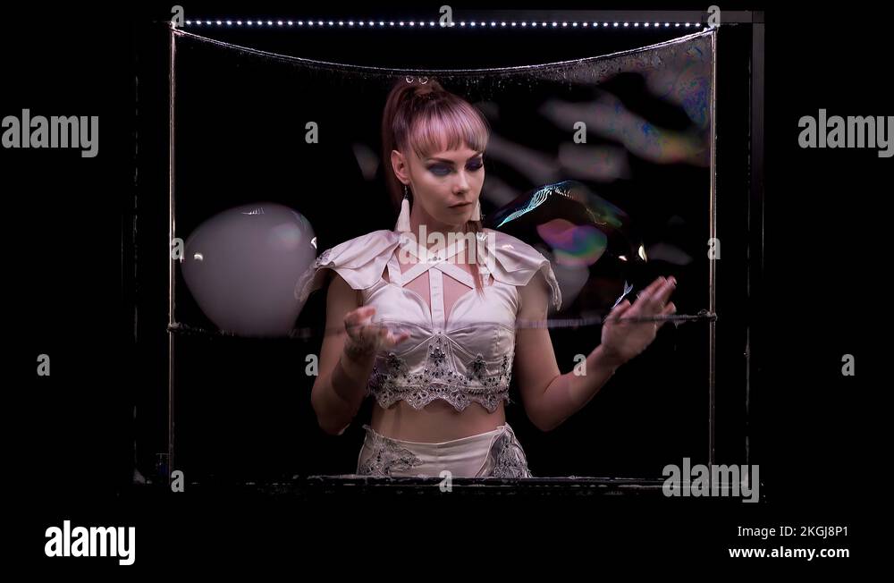 Pretty Girl Plays With Two Big Bubbles Fingers Then Connecting Them