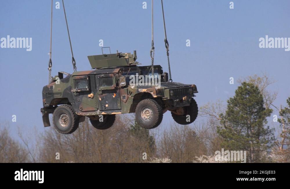 Humvee jeep being lifted with chains during sling load operations Stock ...