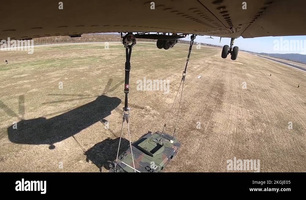 Fuselage view of CH-47 Chinook lifting Humvee sling load Stock Video ...