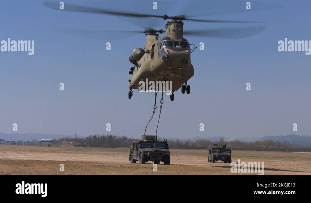 CH-47 Chinook lifting Humvee jeep during sling load operations Stock ...