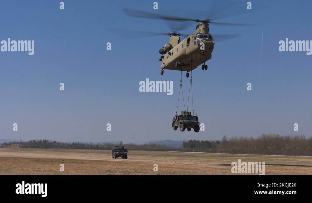 CH-47 Chinook helicopter performs a sling load carrying Humvee jeep Stock Video Footage - Alamy