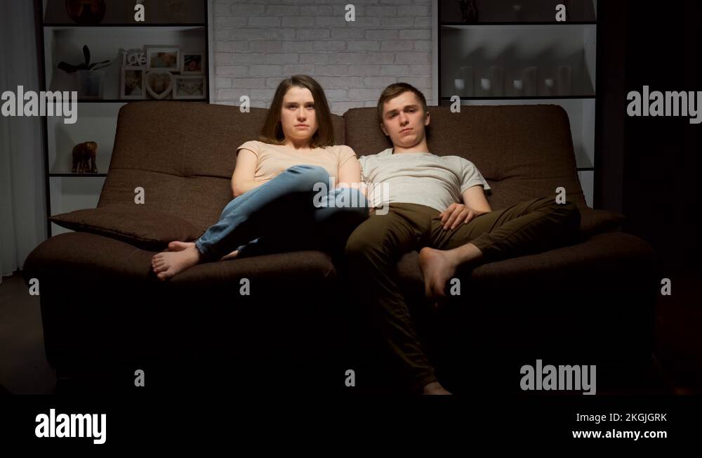 Young people watch a horror movie on TV and shudder in fear Stock Video ...