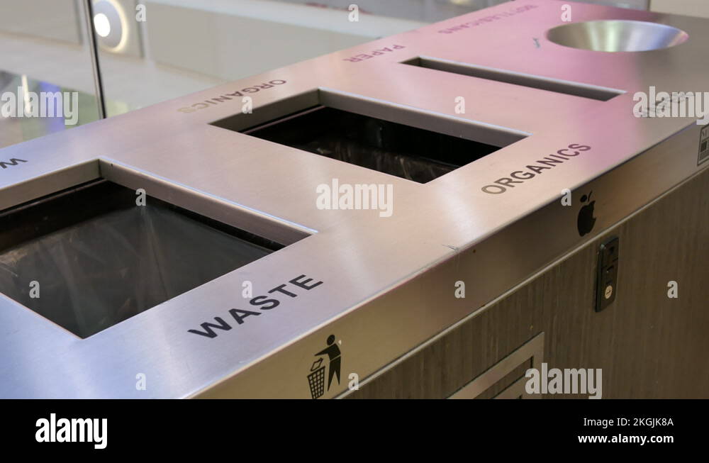 Motion of people throwing trash to the garbage can inside shopping mall ...