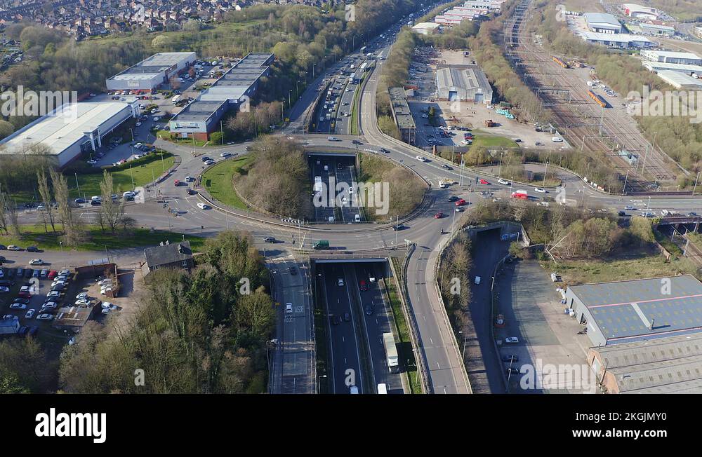 Overhead view of a busy roundabout in the midlands, motorway traffic ...