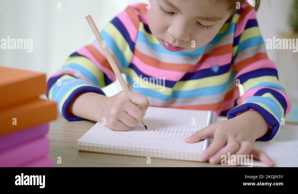 Kid's creativity, Child little asian girl writing in the book on the ...