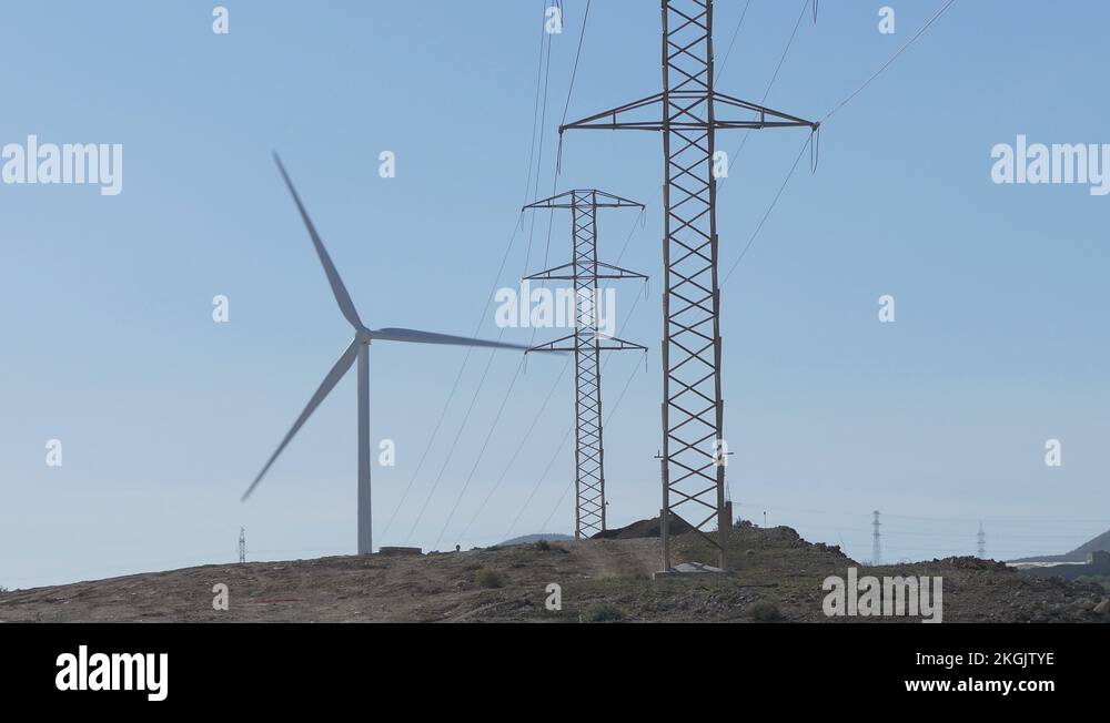 Wind Turbines With Rotating Blades Next to Electrical Towers and Power ...