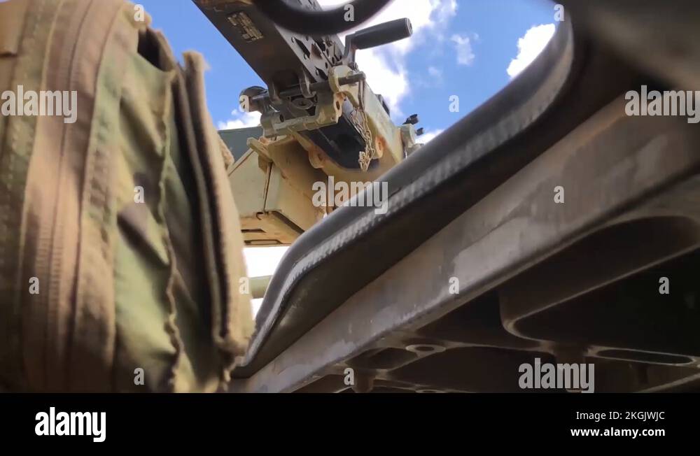 Soldier firing machine gun from armored vehicle in slow motion Stock ...