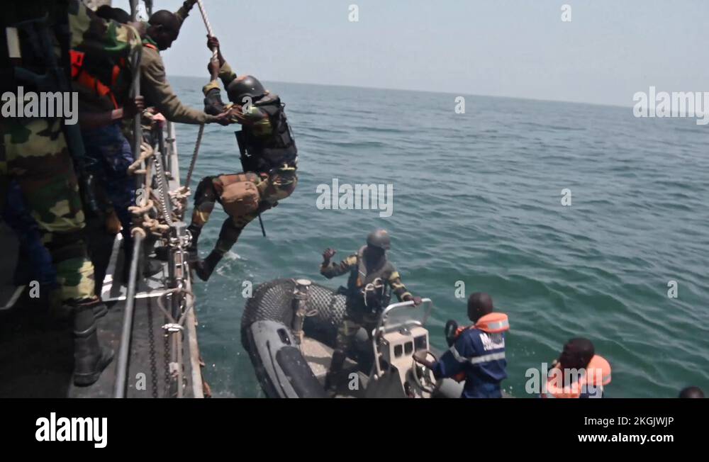 Soldier descending ladder from ship onto RIB during Exercise Obangame ...