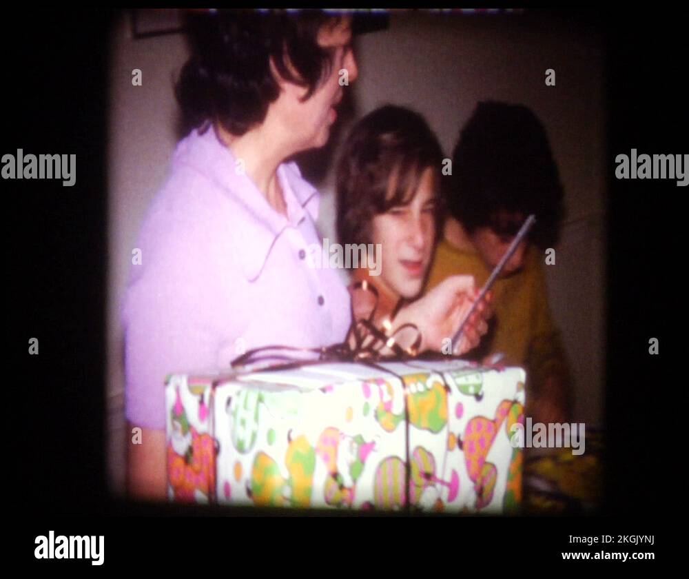 Mom gives long haired son birthday present Stock Video Footage - Alamy