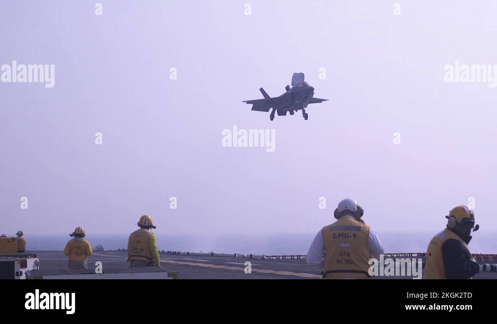 Plane director watch F-35B Lightning II approach flight deck of USS ...