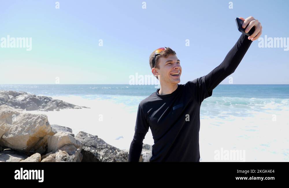 Young happy smiling man talking pictures of him self laughing and ...