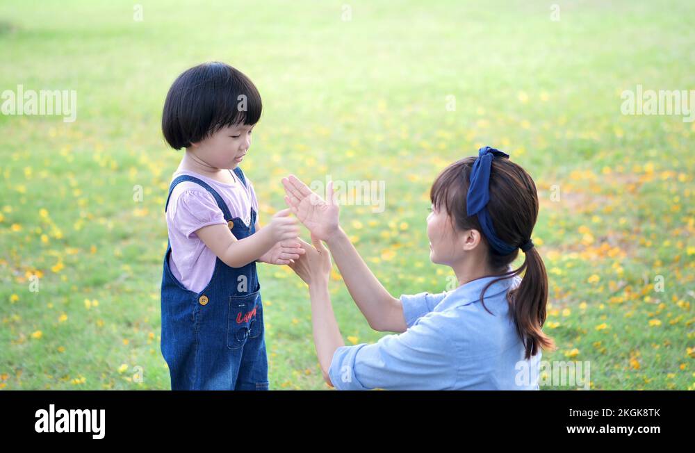 Happiness Asian family Mother and daughter play and clap hands and sing ...