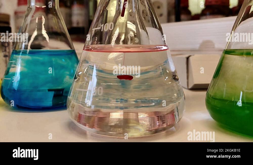 Red chemical drop in water in a chemistry conical flask Stock Video ...