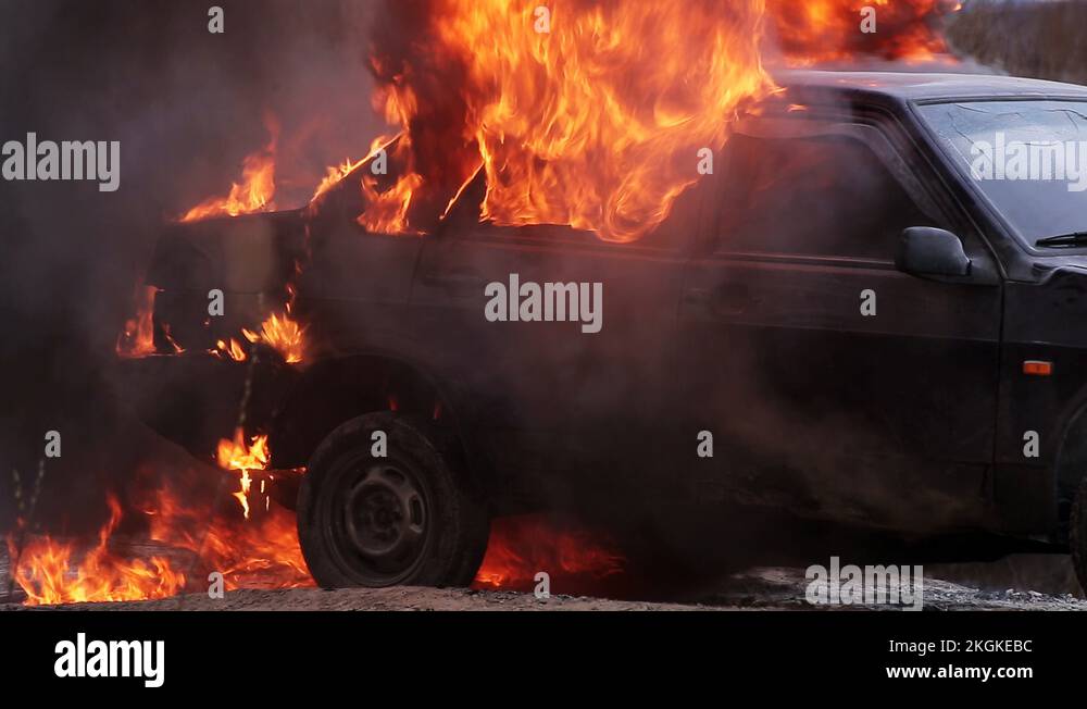Massive orange flame of fire totally burns dirty old car left on ...