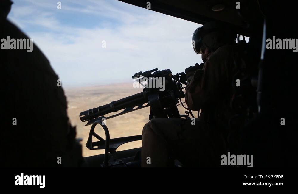 U.S. Marine door gunner firing machine gun from helicopter Stock Video ...
