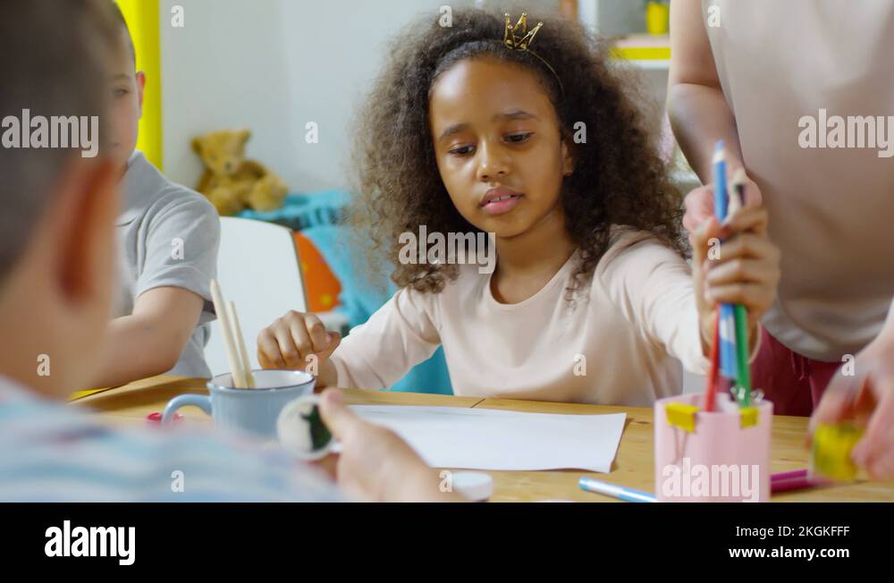 Multiethnic Kids and Female Teacher Cleaning Desk in Art Class Stock ...
