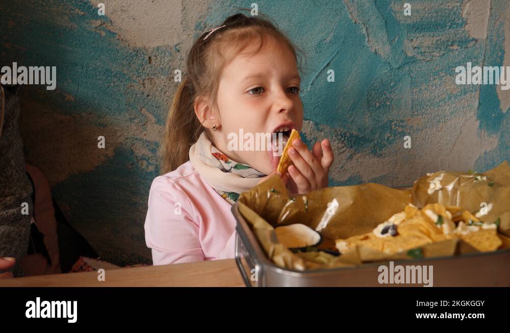 Little child girl portrait in mexican cuisine restaurant eating tasty ...