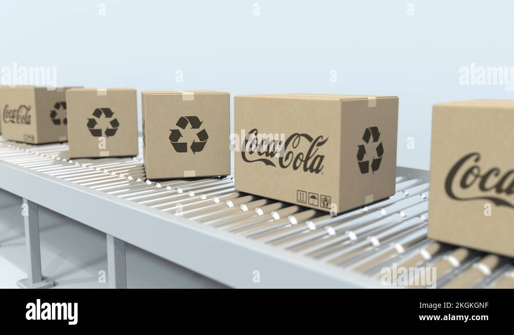 Many cartons with Coca-Cola logo move on roller conveyor. Loopable ...