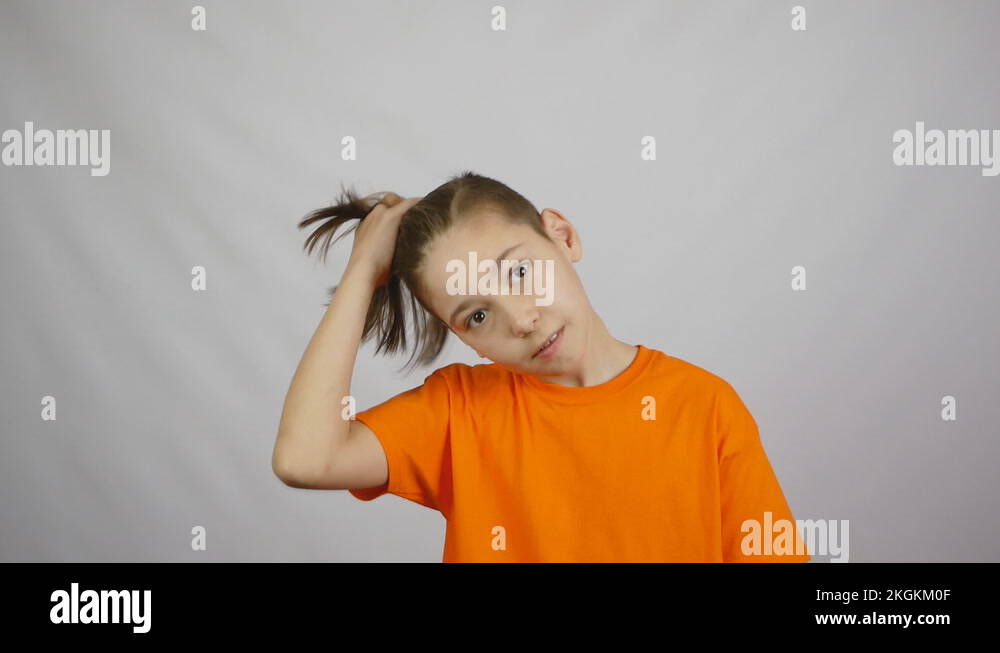 young handsome young man with long hair, shaking his head, straightens ...