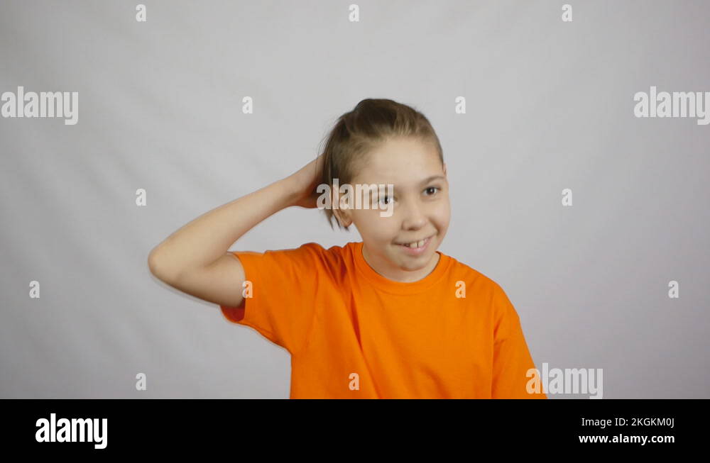 young handsome young man with long hair, shaking his head, straightens ...