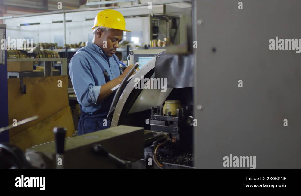 Attentive black lathe operator filling checklist Stock Video Footage ...