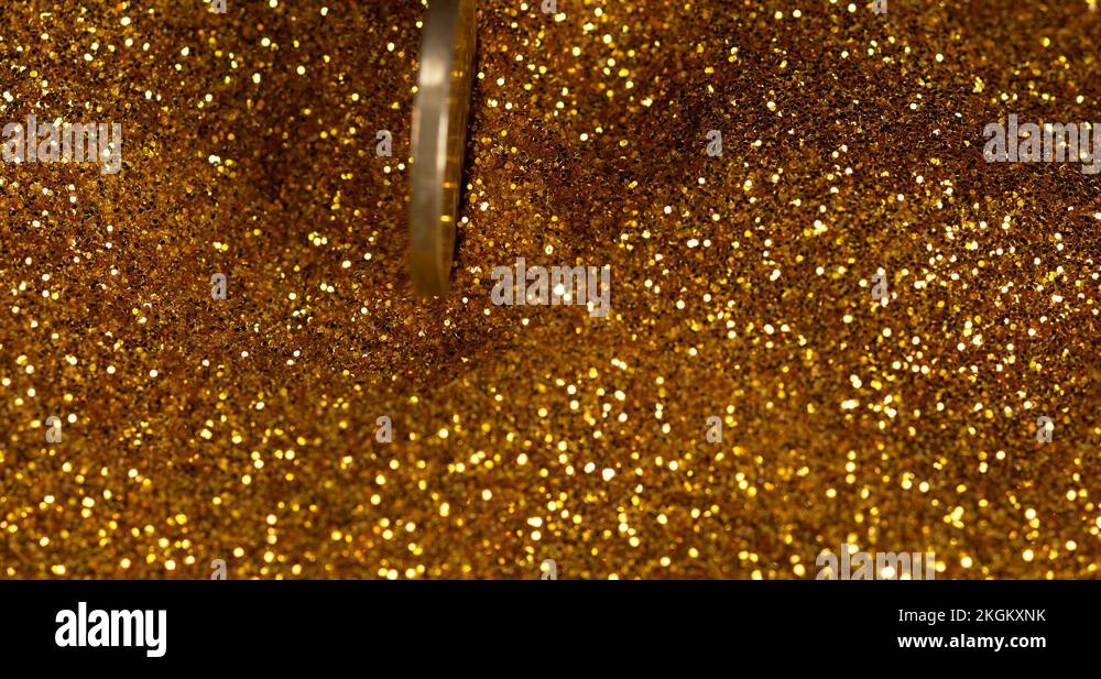 Coin of 1 Euro Rolling on Gold Powder against Black Background, Slow ...