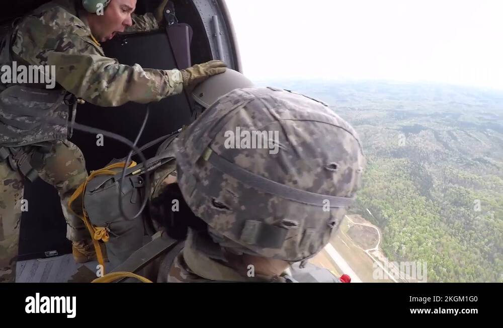 U.S. Army paratroopers jump from UH-60 Black Hawk on jumpmasters signal ...
