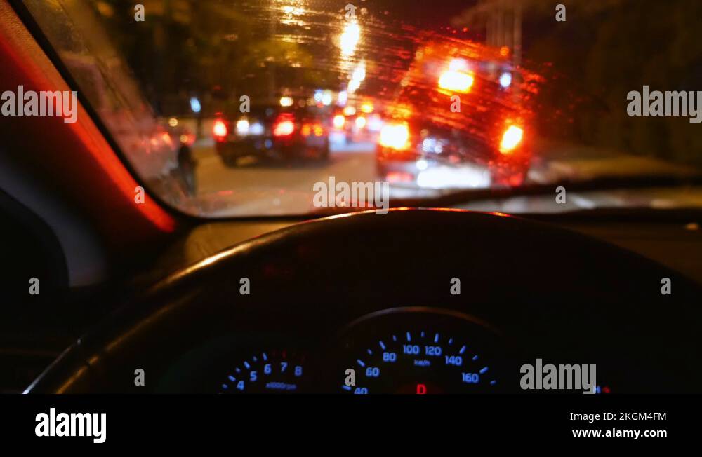 blur, first person view. hand on the steering wheel of the car. driving ...