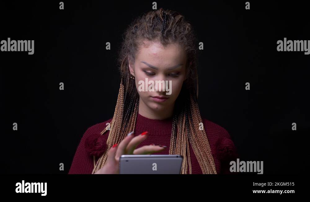 Eccentric girl with dreadlocks demonstrates green screen of tablet ...
