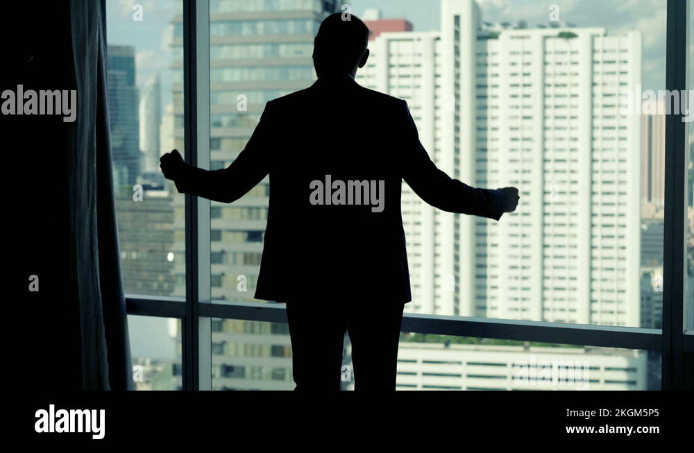 Successful businessman silhouette raising arms, power symbol, in the ...